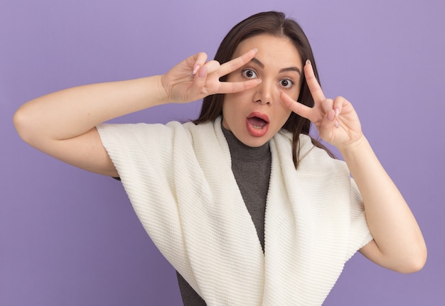 Free Photo Impressed Young Pretty Woman Showing V Sign Symbols Near Eyes
