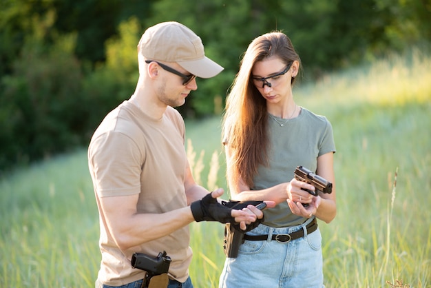 Premium Photo The Instructor Teaches The Girl To Shoot A Pistol At The Range
