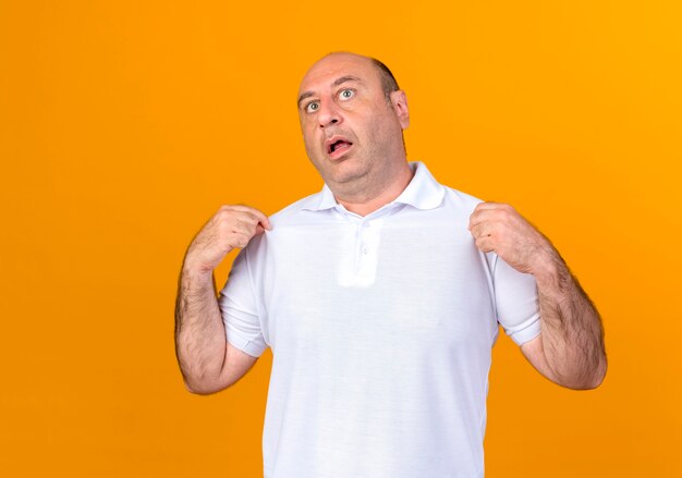 Free Photo Looking At Up Surprised Casual Mature Man Grabbed T Shirt