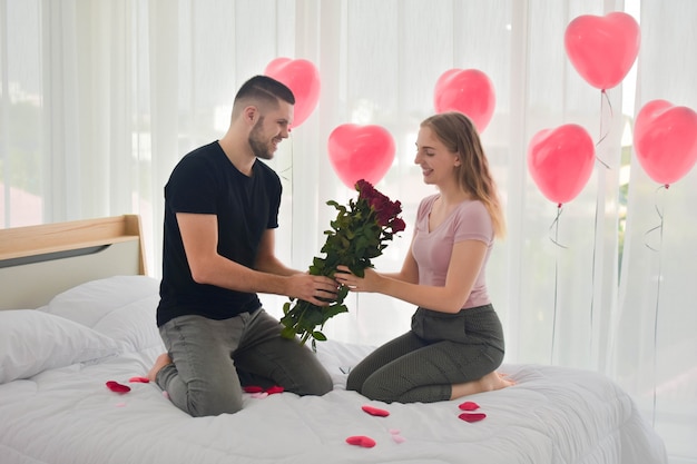 Premium Photo Love Couple Giving Rose Flower In Bedroom Happiness In