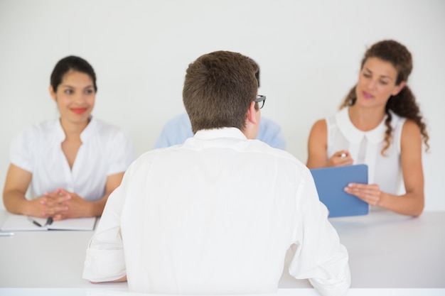Premium Photo | Man being interviewed by business people Premium Photo | Man being interviewed by business people