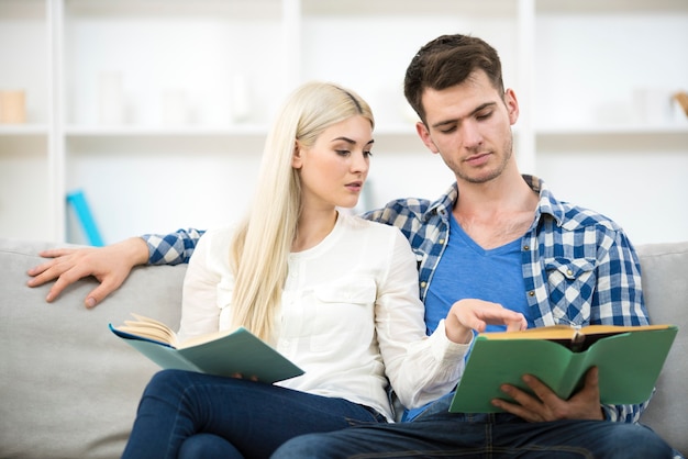 Premium Photo The Man And Woman Reading Books On The Sofaj