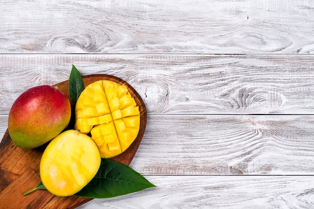 Premium Photo | Mango. tropical fruits. on wooden table. top view. Premium Photo | Mango. tropical fruits. on wooden table. top view.