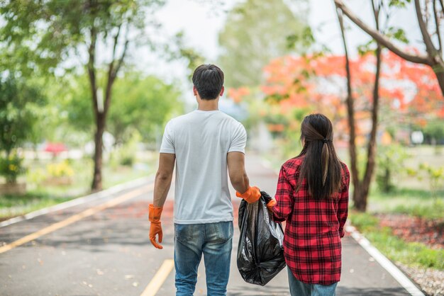 Free Photo | Men and women help each other to collect garbage. Free Photo | Men and women help each other to collect garbage.