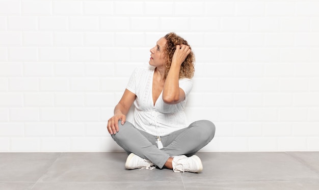 Premium Photo Middle Age Woman Thinking Or Doubting Scratching Head