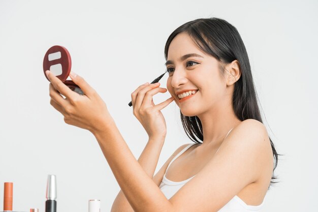 Premium Photo Mixed Race Asian Woman Putting Eye Liner On Eyelid On