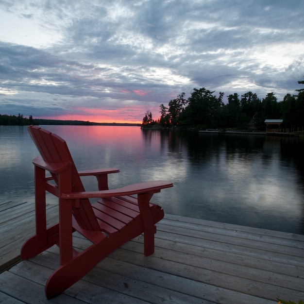 Premium Photo Muskoka Chair On The Dock At Sunset In Lake Of The Woods Ontario