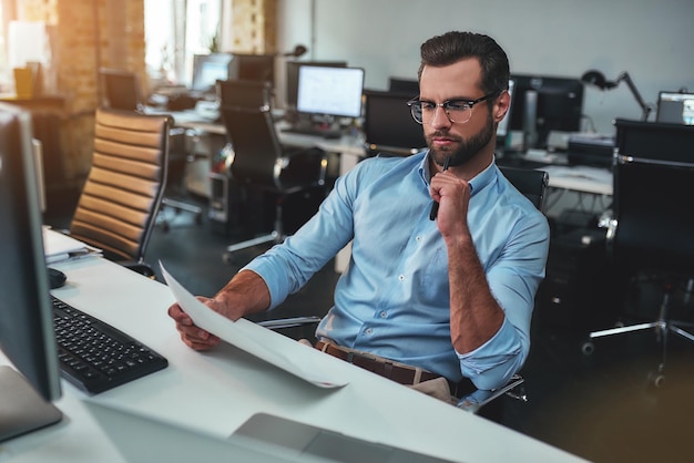 Premium Photo New Strategy Concentrated Bearded Man In Eyeglasses And