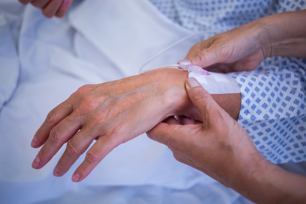 Premium Photo | Nurse attaching iv drip on patient s hand Premium Photo | Nurse attaching iv drip on patient s hand