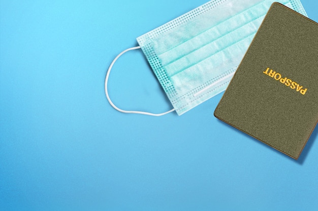 Premium Photo Passport And Face Mask On A Colored Surface Traveling In The New Normal