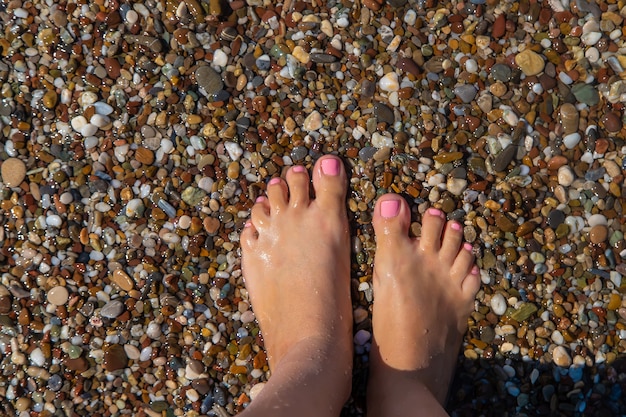 Premium Photo Pebbles Pebbles Woman Feet On The Sea Selective Focus