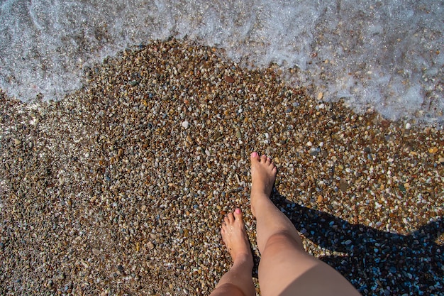 Premium Photo Pebbles Pebbles Woman Feet On The Sea Selective Focus