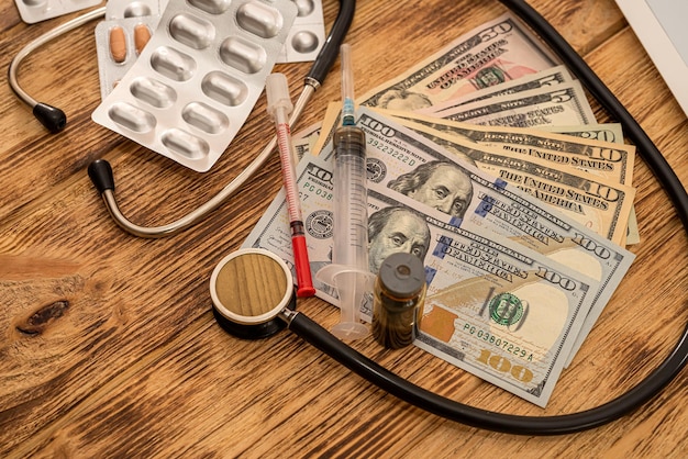 Premium Photo Pills With Banknotes Dollars Stethoscope Syringe