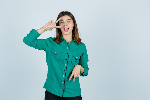 Free Photo Portrait Of Beautiful Young Lady Showing V Sign Near Eye