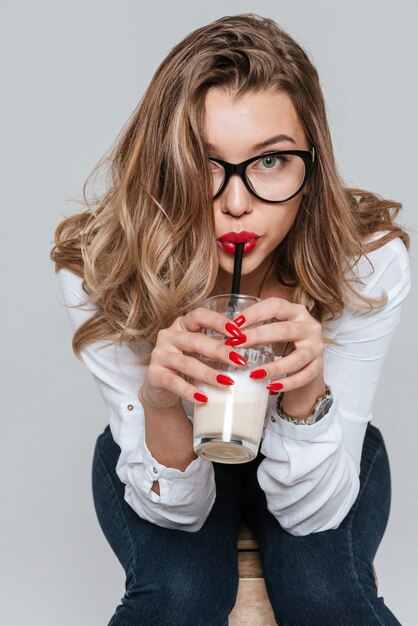 Premium Photo Portrait Of A Casual Young Woman In Eyeglasses Sitting