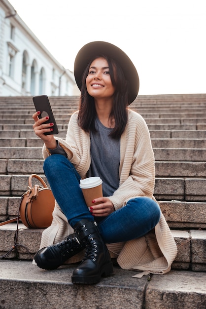 Free Photo | Portrait of a cheery smiling woman texting on mobile phone Free Photo | Portrait of a cheery smiling woman texting on mobile phone