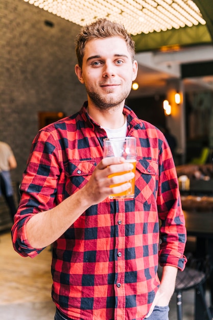 Free Photo | Portrait of a happy young man holding the beer glass ... Free Photo | Portrait of a happy young man holding the beer glass ...