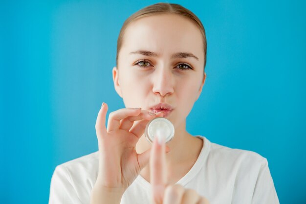 Premium Photo Portrait Of Joyful Girl Covering Her Eye By A Cream Can