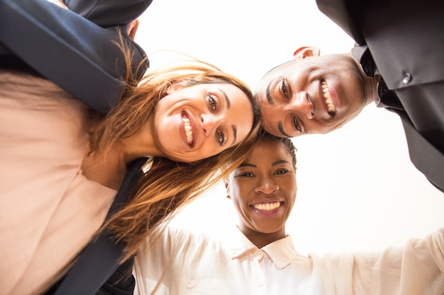Free Photo | Portrait of smiling colleagues embracing and looking at camera Free Photo | Portrait of smiling colleagues embracing and looking at camera