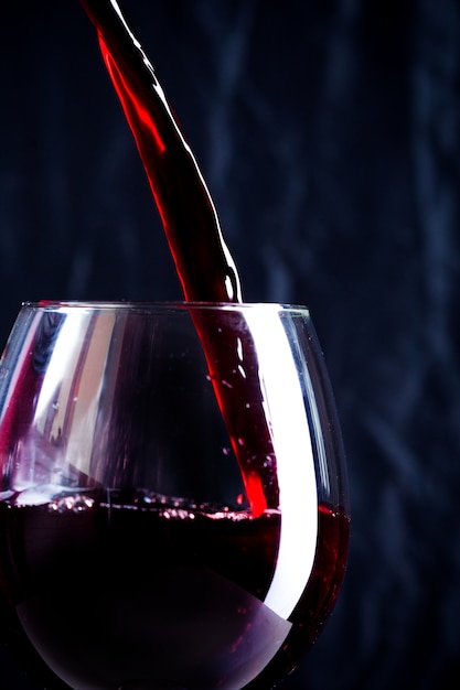 Premium Photo Pouring Red Wine Into The Glass