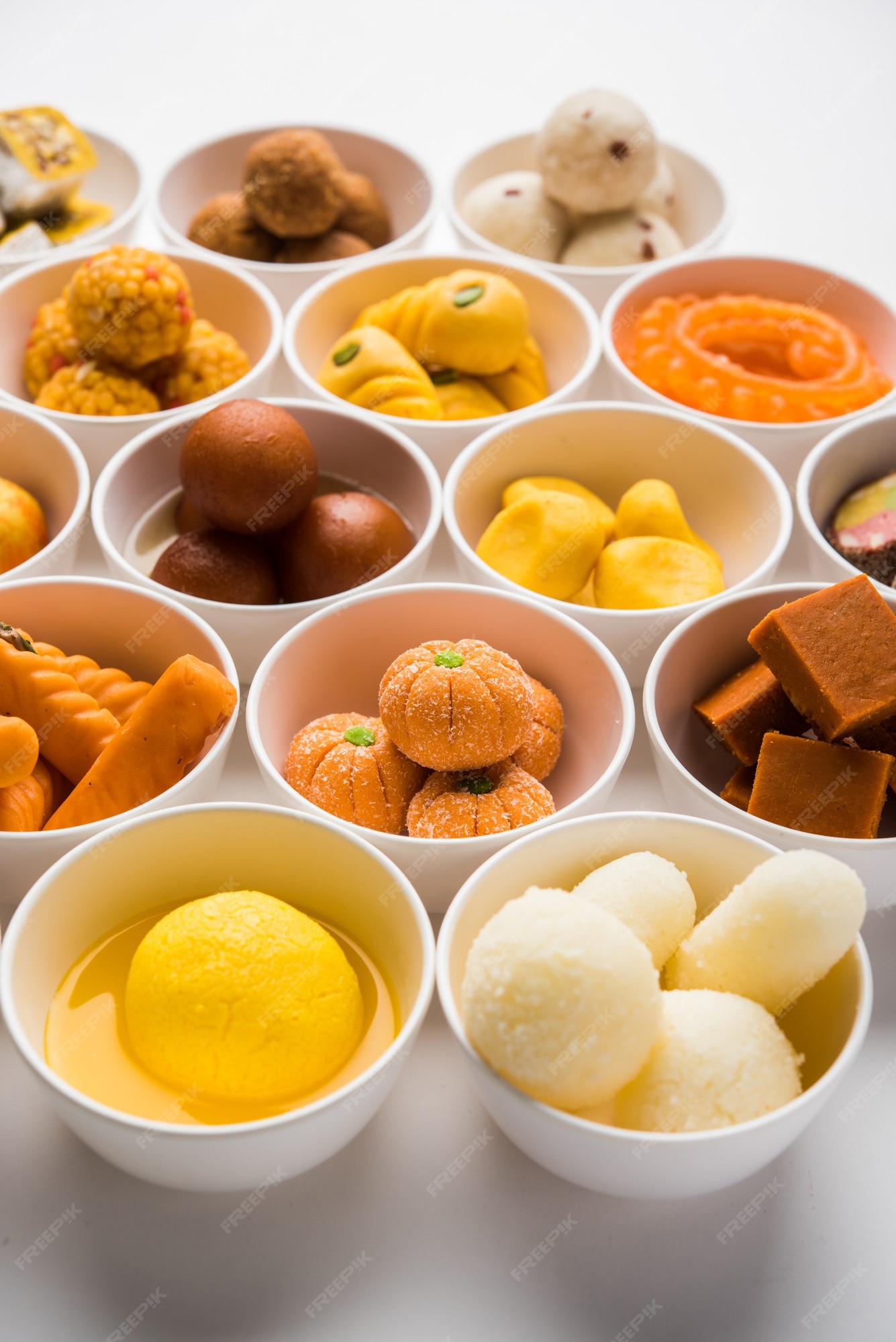 Premium Photo Rangoli Of Assorted Indian Sweets Or Mithai In Bowl For