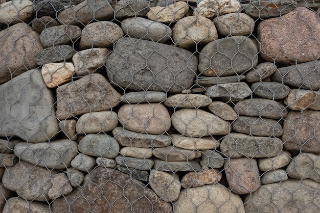 Premium Photo | Reinforcement of stones that are fixed in the net of rowan. Premium Photo | Reinforcement of stones that are fixed in the net of rowan.