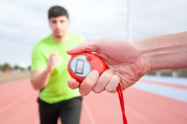 Premium Photo | Runner and timer in running track Premium Photo | Runner and timer in running track
