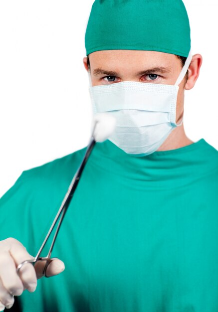 Premium Photo | Self-assured male surgeon holding surgical forceps Premium Photo | Self-assured male surgeon holding surgical forceps