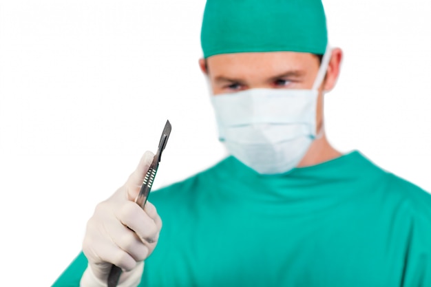 Premium Photo | Self-assured surgeon holding a scalpel Premium Photo | Self-assured surgeon holding a scalpel