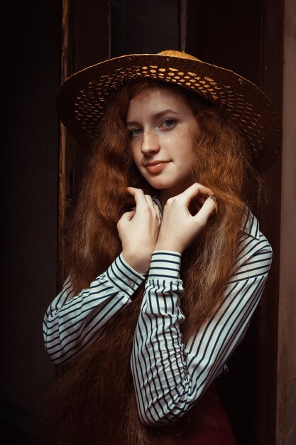 Premium Photo Sensual Redhead Woman With Long Curly Hair In Straw Hat