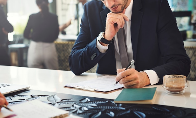Premium Photo | Serious business man filling out form concept Premium Photo | Serious business man filling out form concept