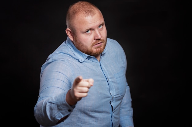 Premium Photo A Serious Fat Redhead Man With A Beard Points A Finger