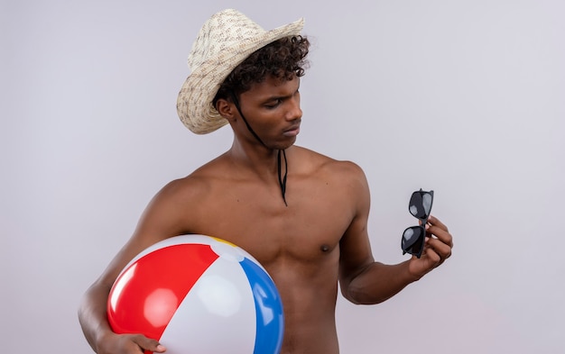 Free Photo A Serious Young Handsome Dark Skinned Man With Curly Hair