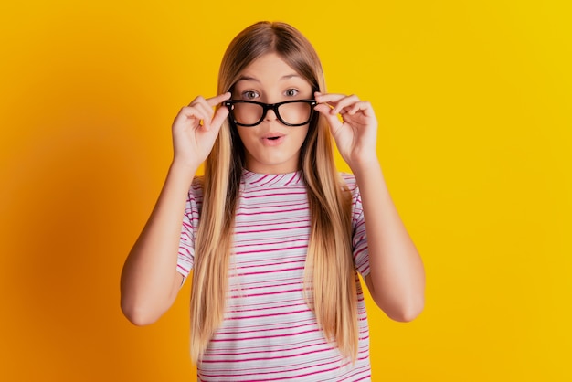 Premium Photo Shocked Girl Pull Glasses Down Isolated On Yellow Background