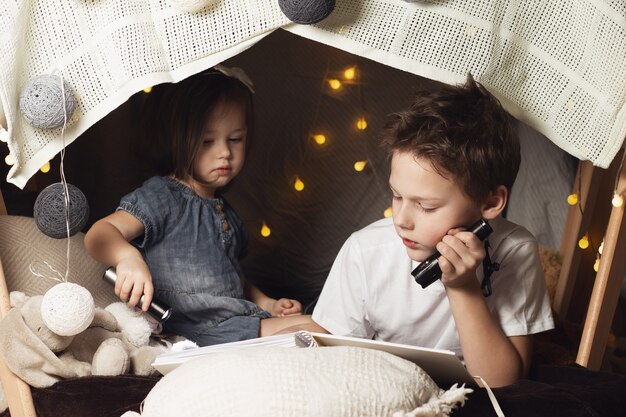 Premium Photo Siblings Lie In Hut Of Chairs And Blankets Brother And