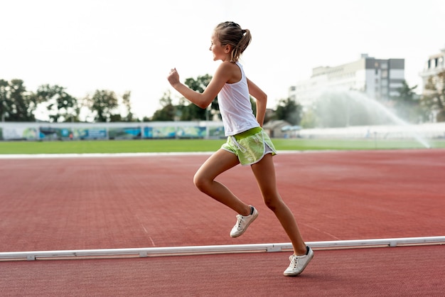 Side View Of Girl On Running Track Photo Free Download