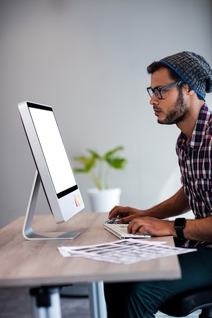 Premium Photo | Side view of serious casual man working at computer desk Premium Photo | Side view of serious casual man working at computer desk