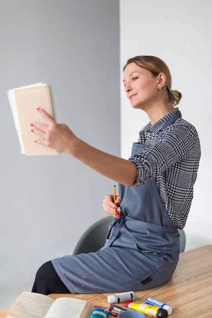 Free Photo | Side view of woman holding notebook Free Photo | Side view of woman holding notebook