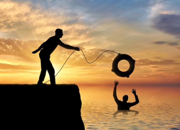 Premium Photo | A silhouette of a man throws a lifeline to another man ... Premium Photo | A silhouette of a man throws a lifeline to another man ...