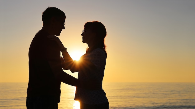 Premium Photo Silhouette Young Man And Woman Are In Love Looking At