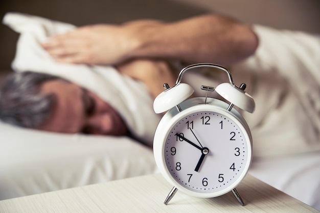 Free Photo | Sleepy young man covering ears with pillow as he looks at ... Free Photo | Sleepy young man covering ears with pillow as he looks at ...