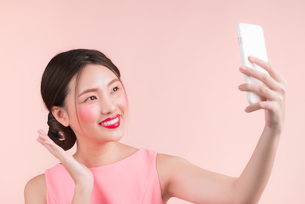 Premium Photo Smiling Lovely Active Asian Girl Taking Selfie Photo