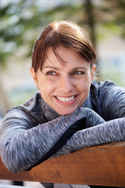 Premium Photo | Smiling sports woman sitting outside Premium Photo | Smiling sports woman sitting outside