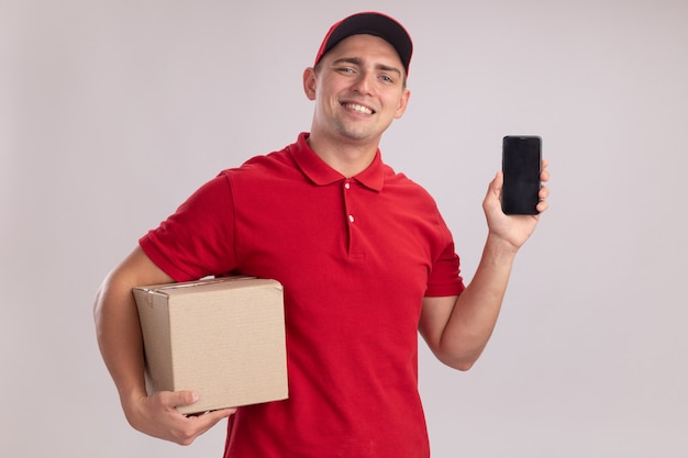 Free Photo Smiling Young Delivery Man Wearing Uniform With Cap