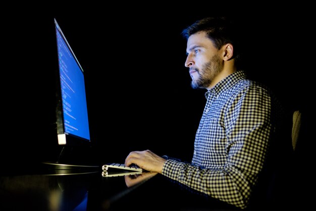 Premium Photo Software Developer Computer At Dark Home Office