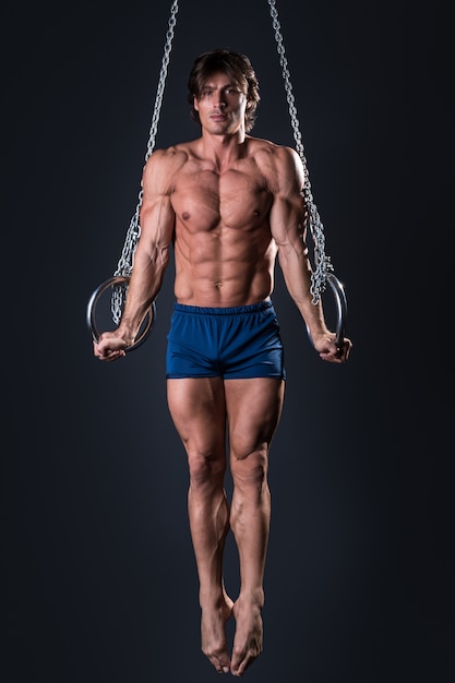 Premium Photo | Strong gymnast guy on the rings Premium Photo | Strong gymnast guy on the rings