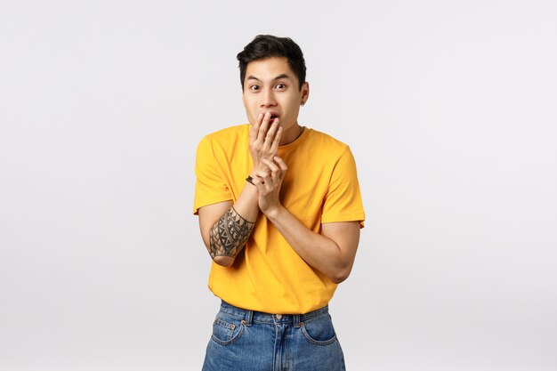 Premium Photo Surprised Handsome Young Asian Man In Yellow T Shirt