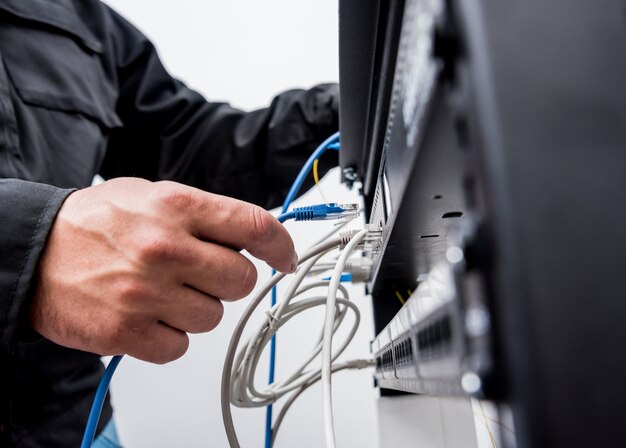 Premium Photo | Technician connecting network cables to switches ... Premium Photo | Technician connecting network cables to switches ...