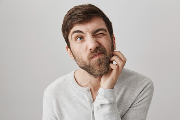 Free Photo | Thoughtful indecisive bearded man scratch beard and ... Free Photo | Thoughtful indecisive bearded man scratch beard and ...