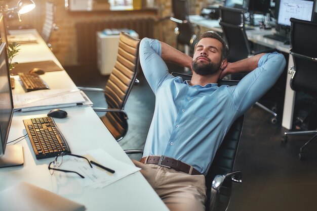 Premium Photo | Time to relax satisfied young bearded businessman ... Premium Photo | Time to relax satisfied young bearded businessman ...